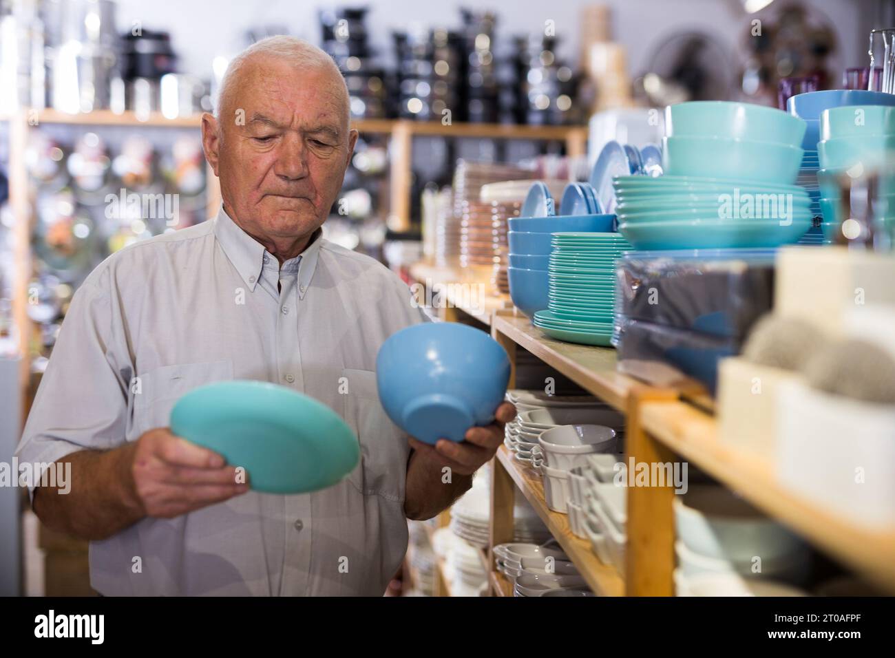 Senior man choosing variety goods for kitchen Stock Photo - Alamy