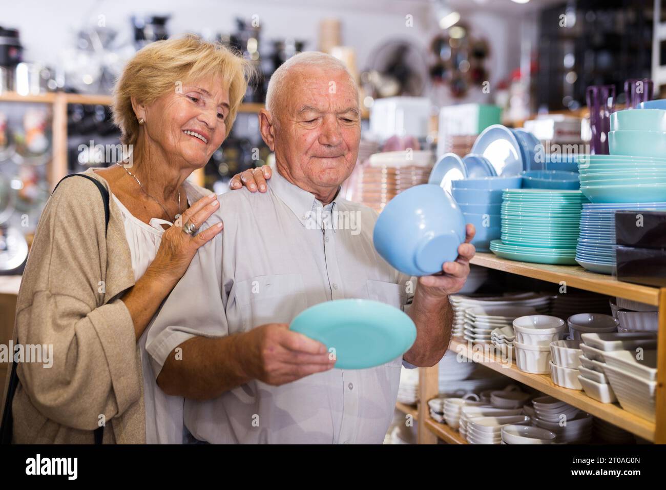 Couple elderly customers buying dishes Stock Photo - Alamy