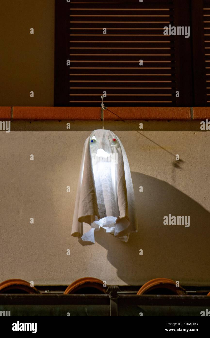 Ghost hanging on the window for Halloween Stock Photo - Alamy