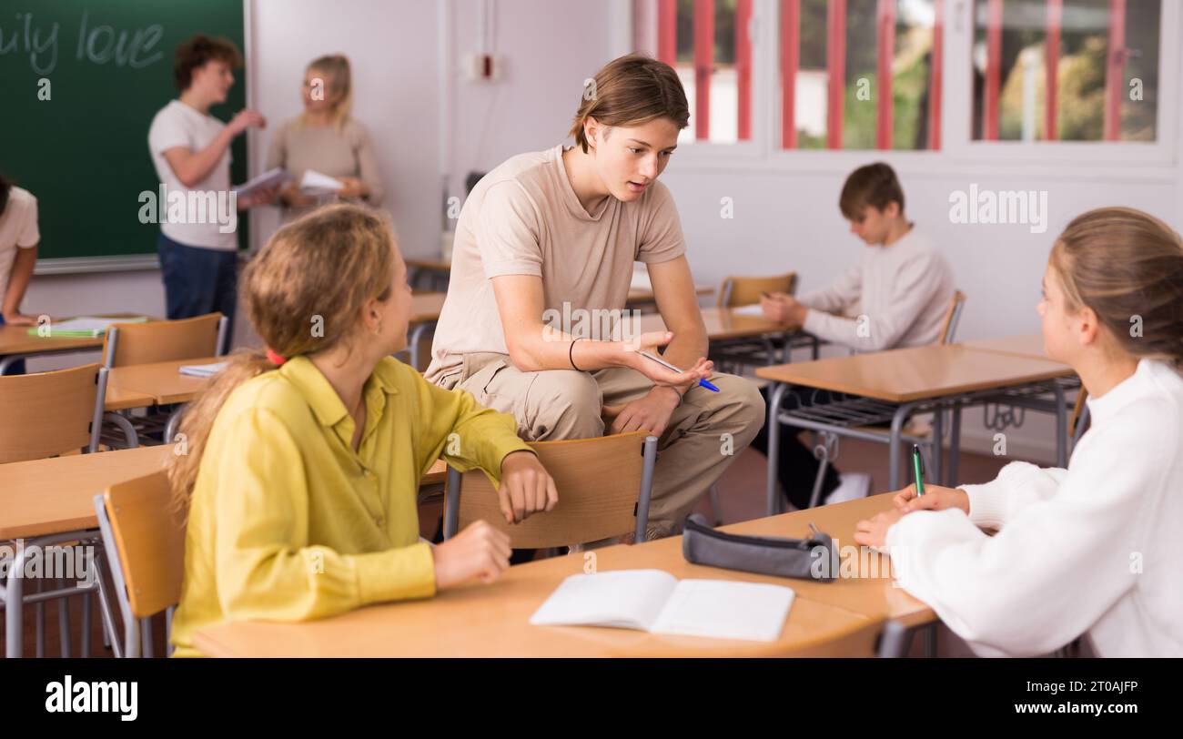 Teenagers during recess in classroom Stock Photo - Alamy