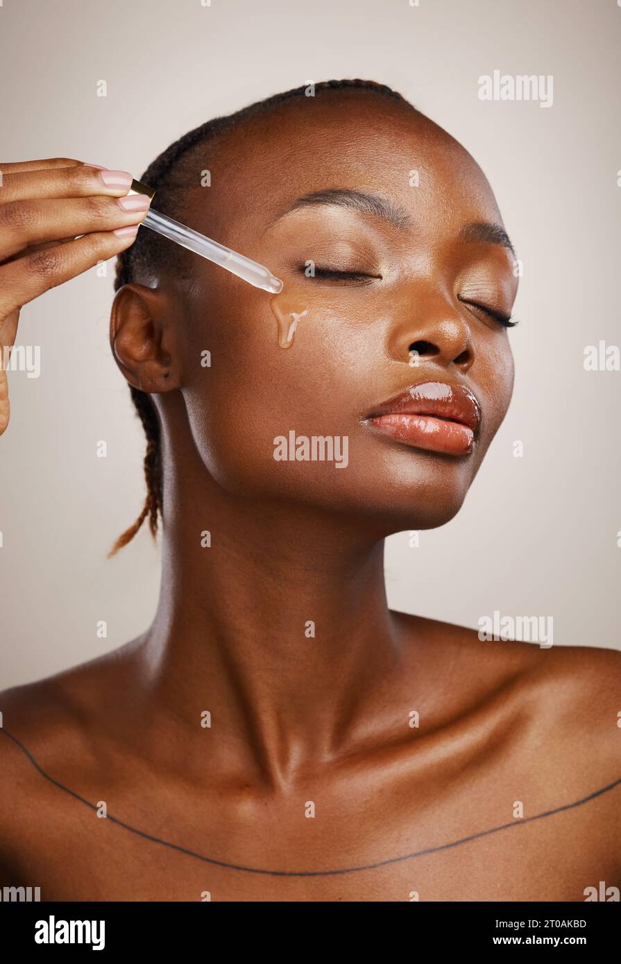 Woman, beauty and oil on face in studio for aesthetic skincare ...