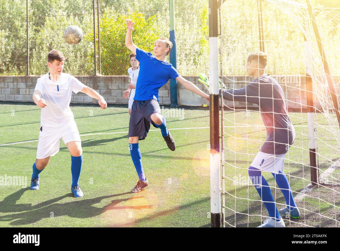 Football player hits ball with his head towards goal Stock Photo - Alamy