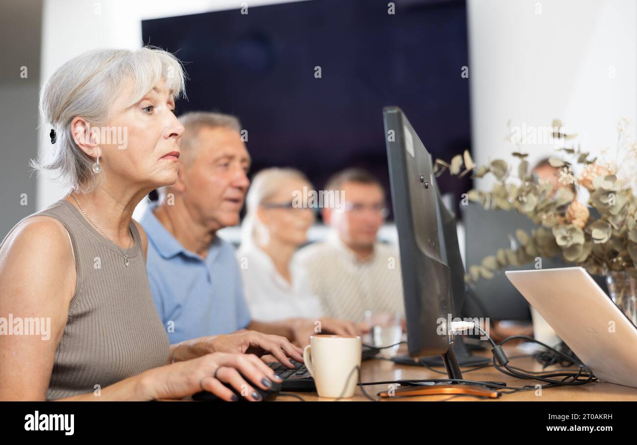 Focused senior woman attending computer class for older adults Stock Photo - Alamy