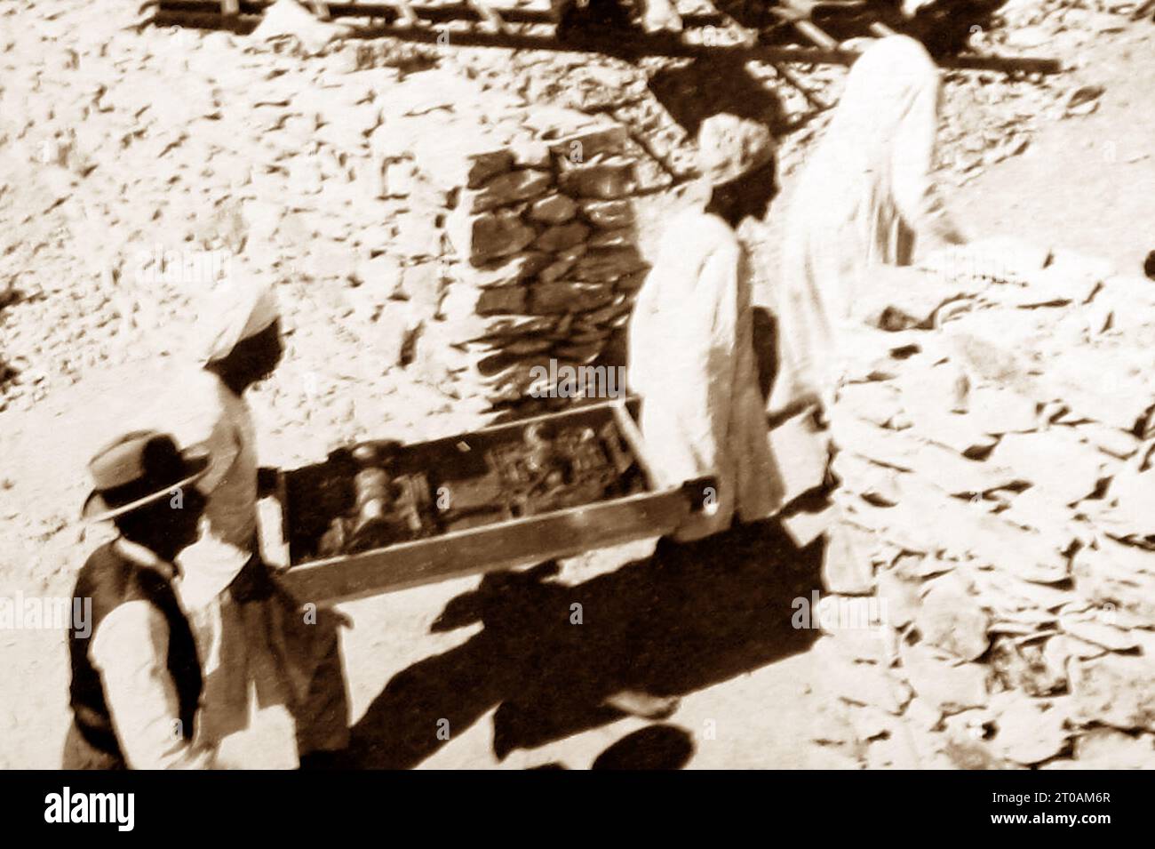 Howard Carter supervising artifacts being removed from the tomb of ...