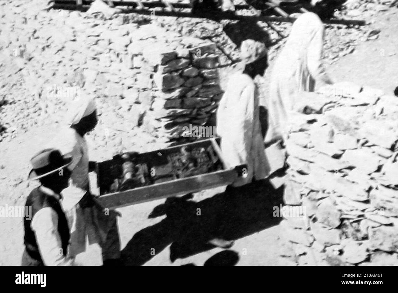 Howard Carter supervising artifacts being removed from the tomb of ...