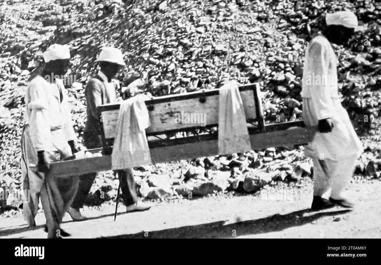 Howard Carter supervising artifacts being removed from the tomb of ...