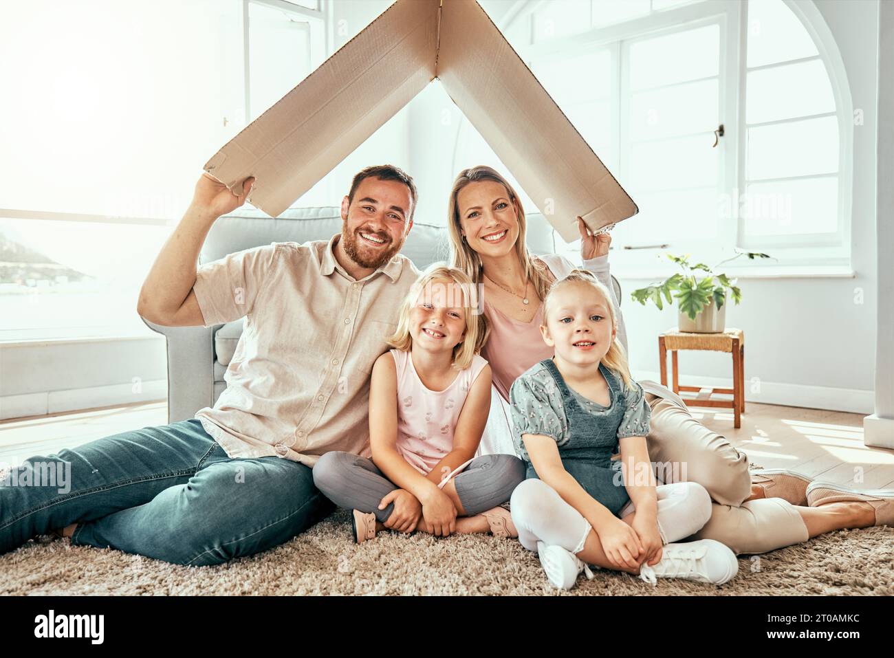 Happy family, portrait and cardboard roof for real estate, moving in or ...