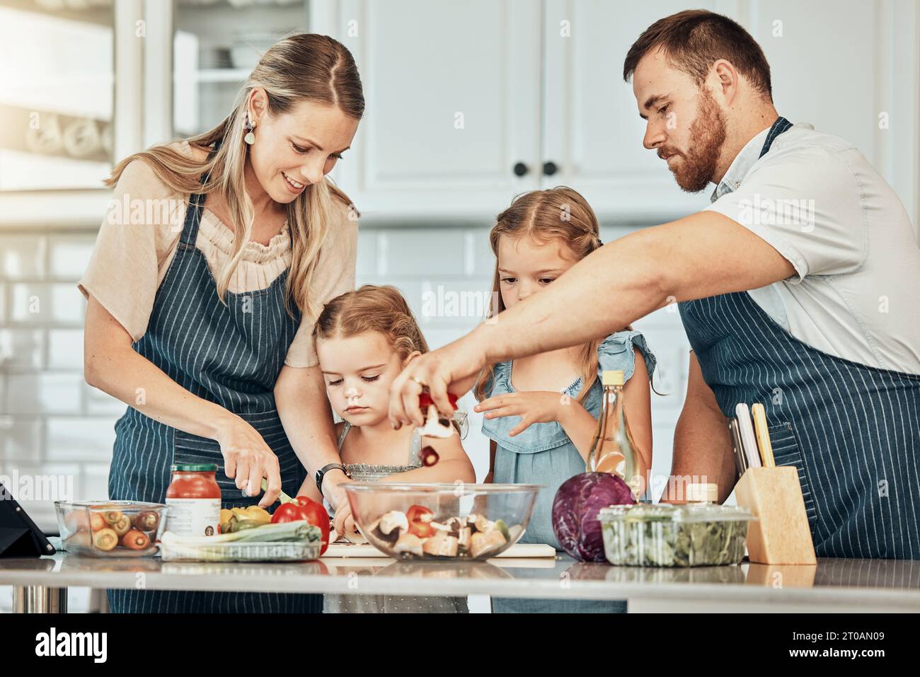 Happy family in kitchen, cooking together with kids and teaching ...