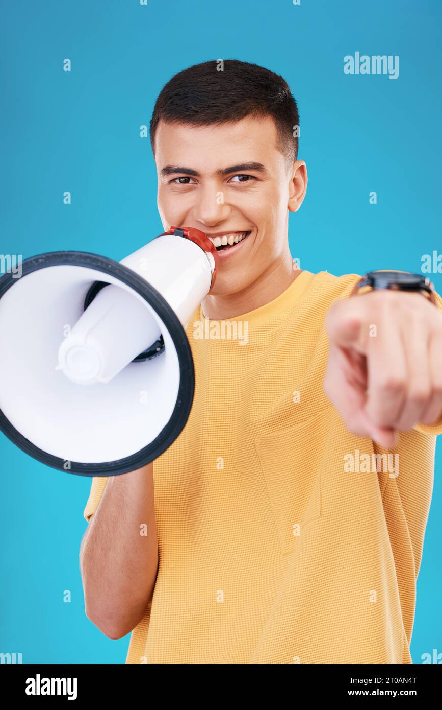 Megaphone, happy and portrait of man in studio pointing for ...