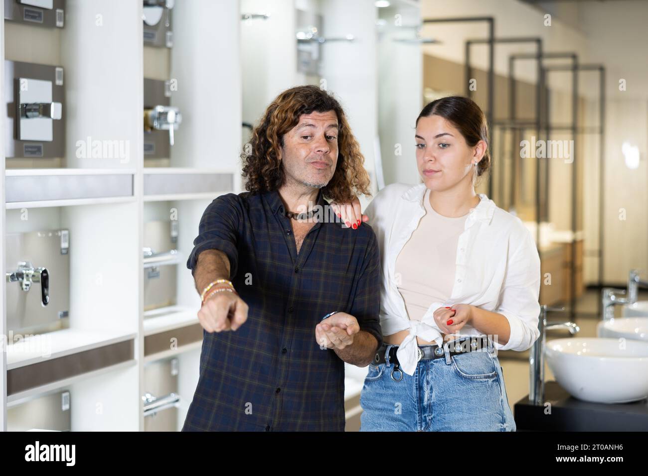Woman and man discussing shopping list and pointing to something in ...