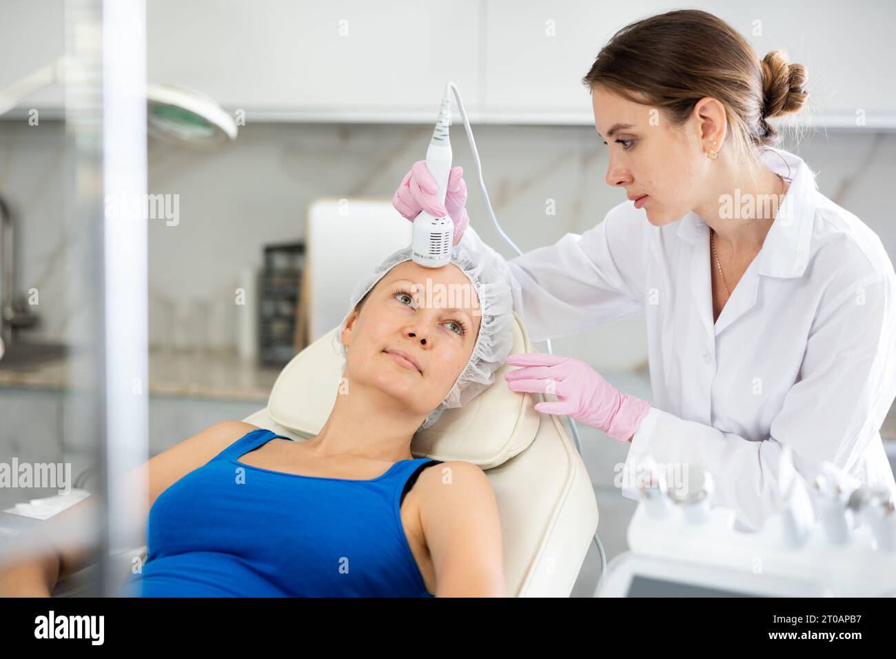 Professional beautician makes cryotherapy for rejuvenation woman face ...