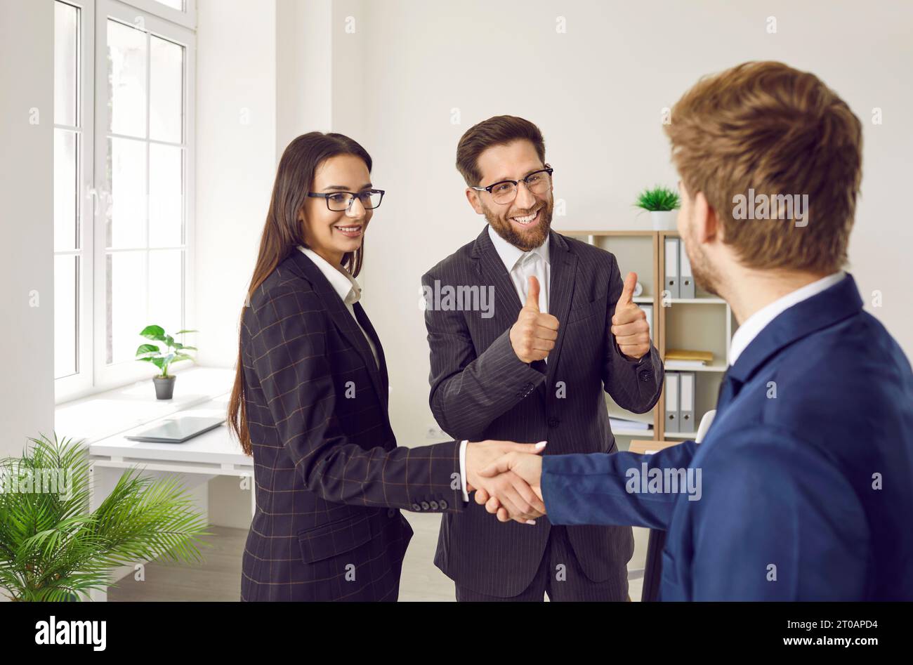 Businessman thumbs up hand shake hi-res stock photography and images ...