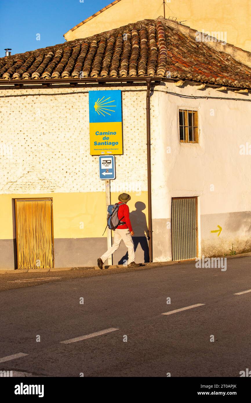 Pilgrim walking over the bridge in the Spanish town of Carrion while ...