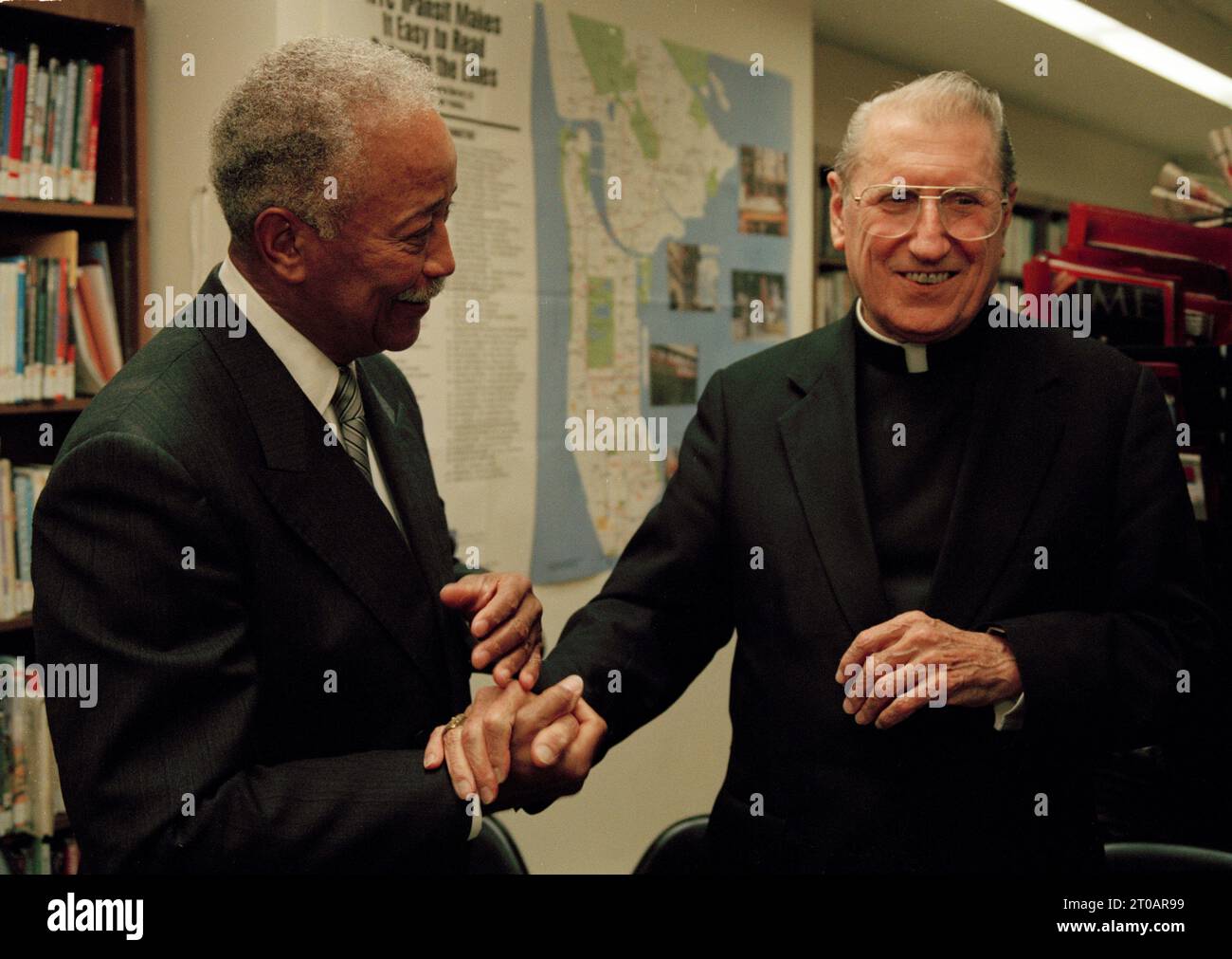 New York City Mayor David Dinkins, left, shakes hands with Cardinal ...