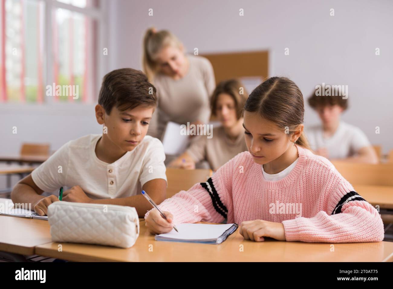 Boy and girl studying in classroom Stock Photo - Alamy