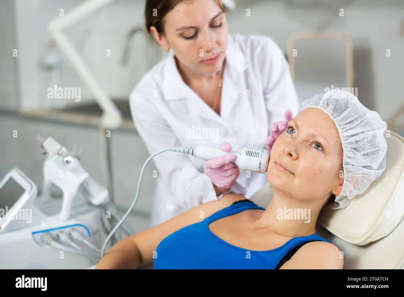 Professional beautician makes cryotherapy for rejuvenation woman face ...