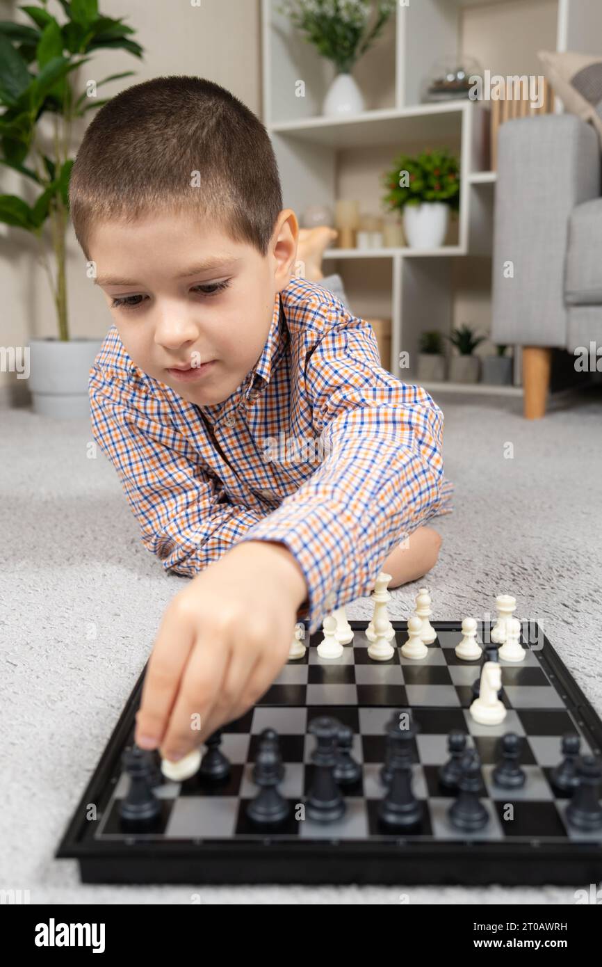 Little boy playing chess. Board games for children Stock Photo - Alamy