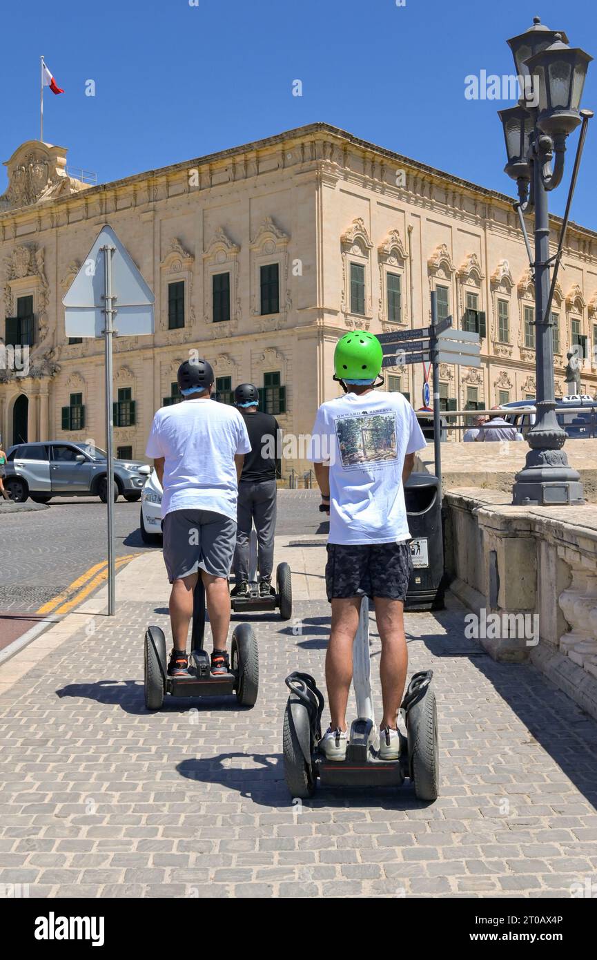 Valletta, Malta - 3 August 2023: Group of visitors to the city riding ...