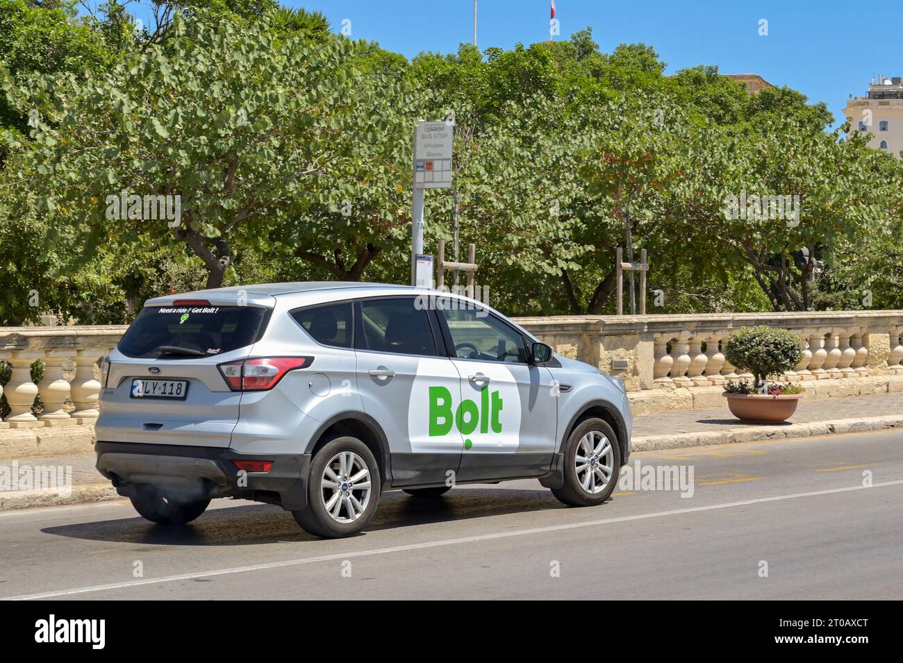 Valletta, Malta - 3 August 2023: Bolt taxi driving down a street in the ...