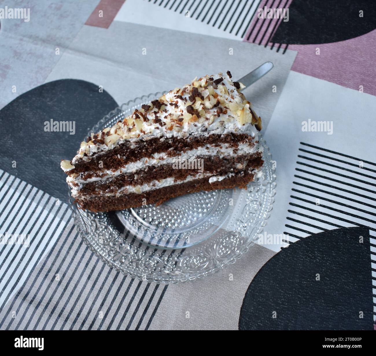 Top view of a homemade triangle piece of chocolate cake with almonds on ...