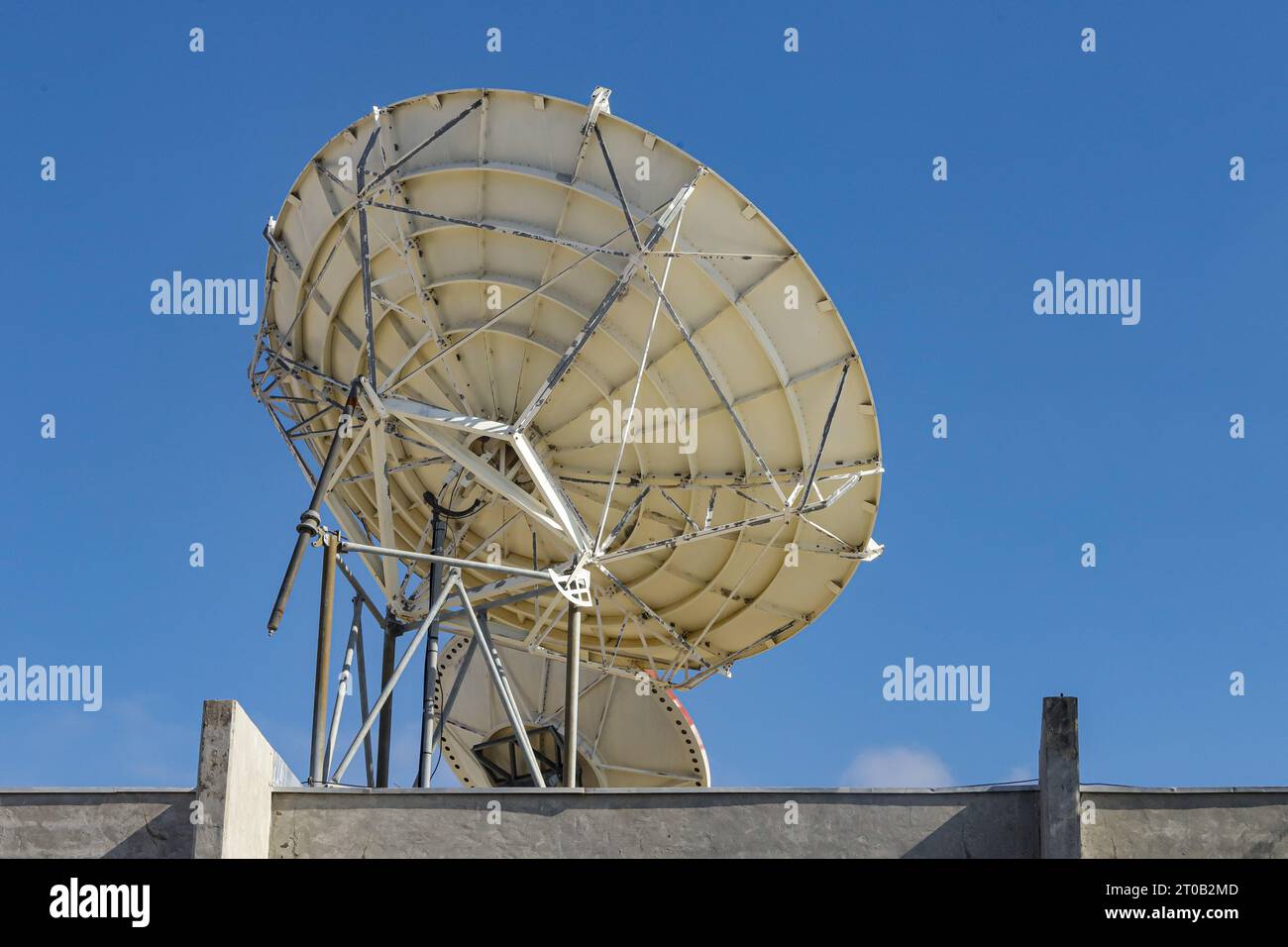 Communication antennas of the parabolic type, white in color with wear ...