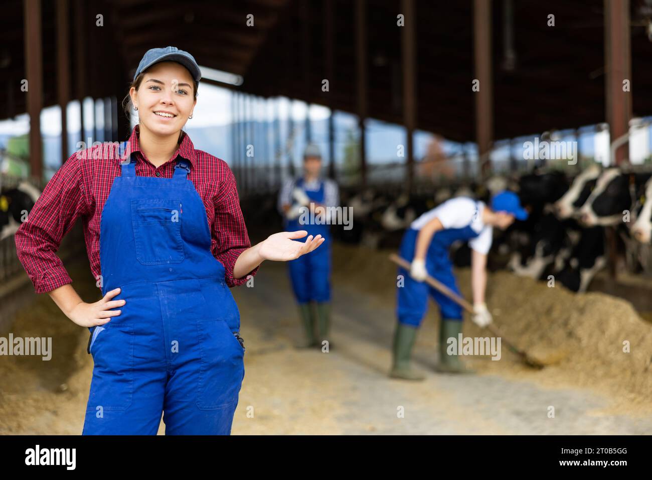 Farmer woman shows cow farm Stock Photo - Alamy