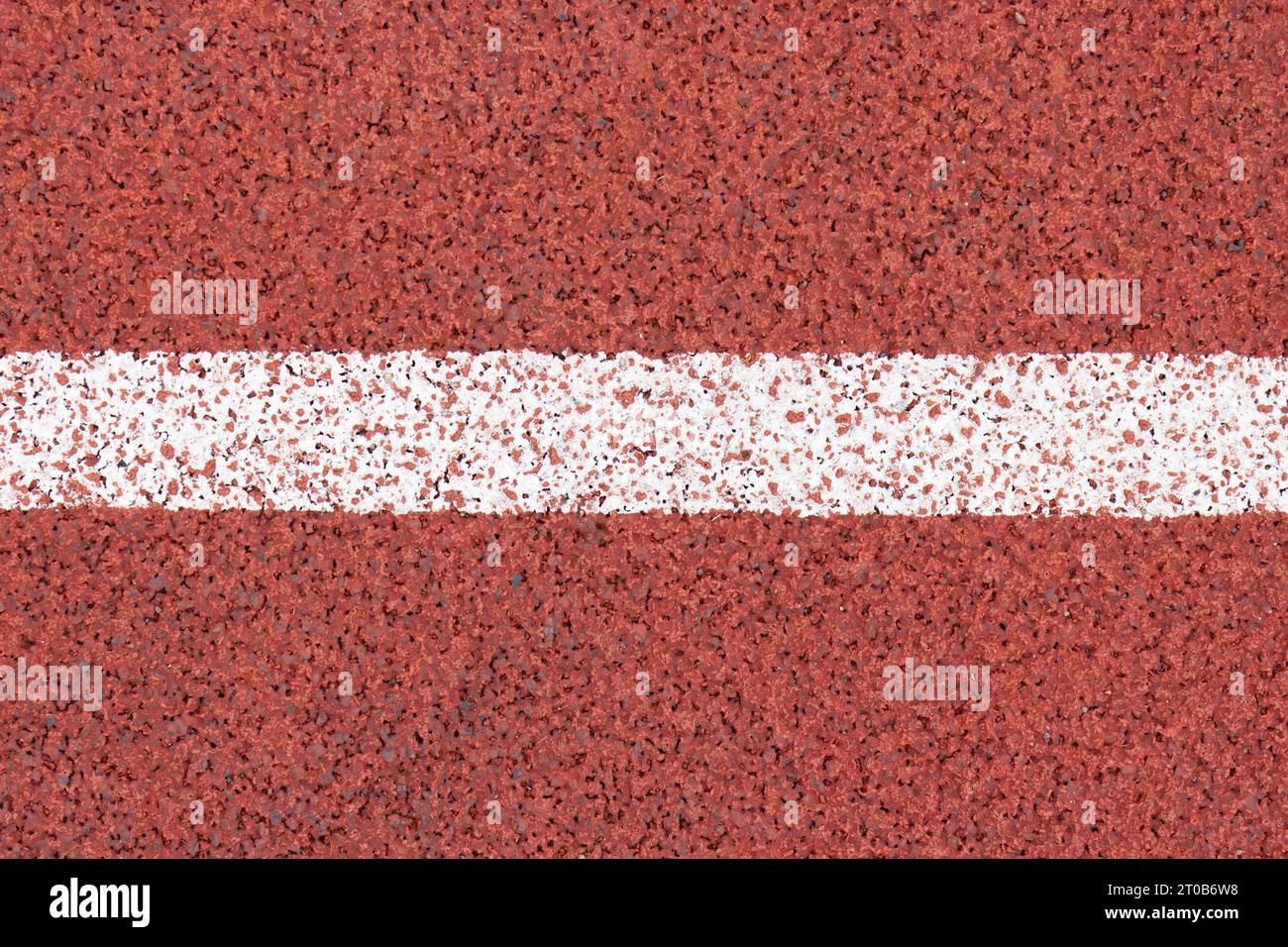 A white line drawn horizontally on a red background. Boundary line on a ...