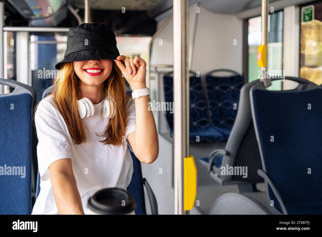 Urban stylish girl teenager has fun while traveling city shuttle bus ...