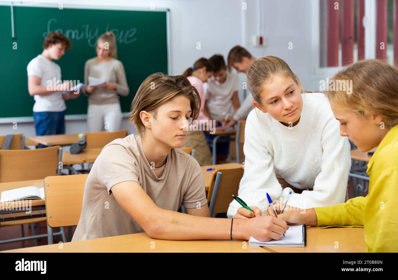 Fellow students having group work tasks during school class Stock Photo ...