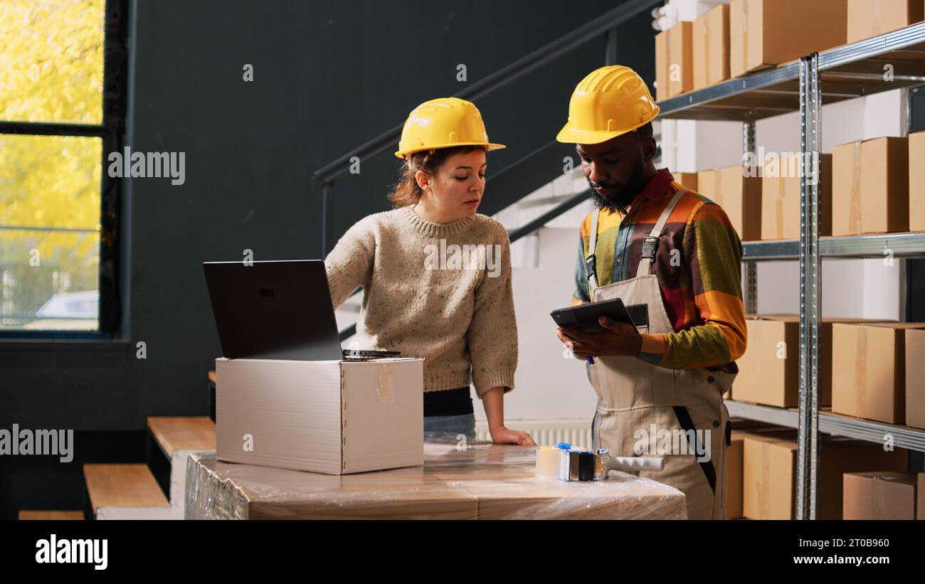 Diverse employees examining packs goods hi-res stock photography and ...