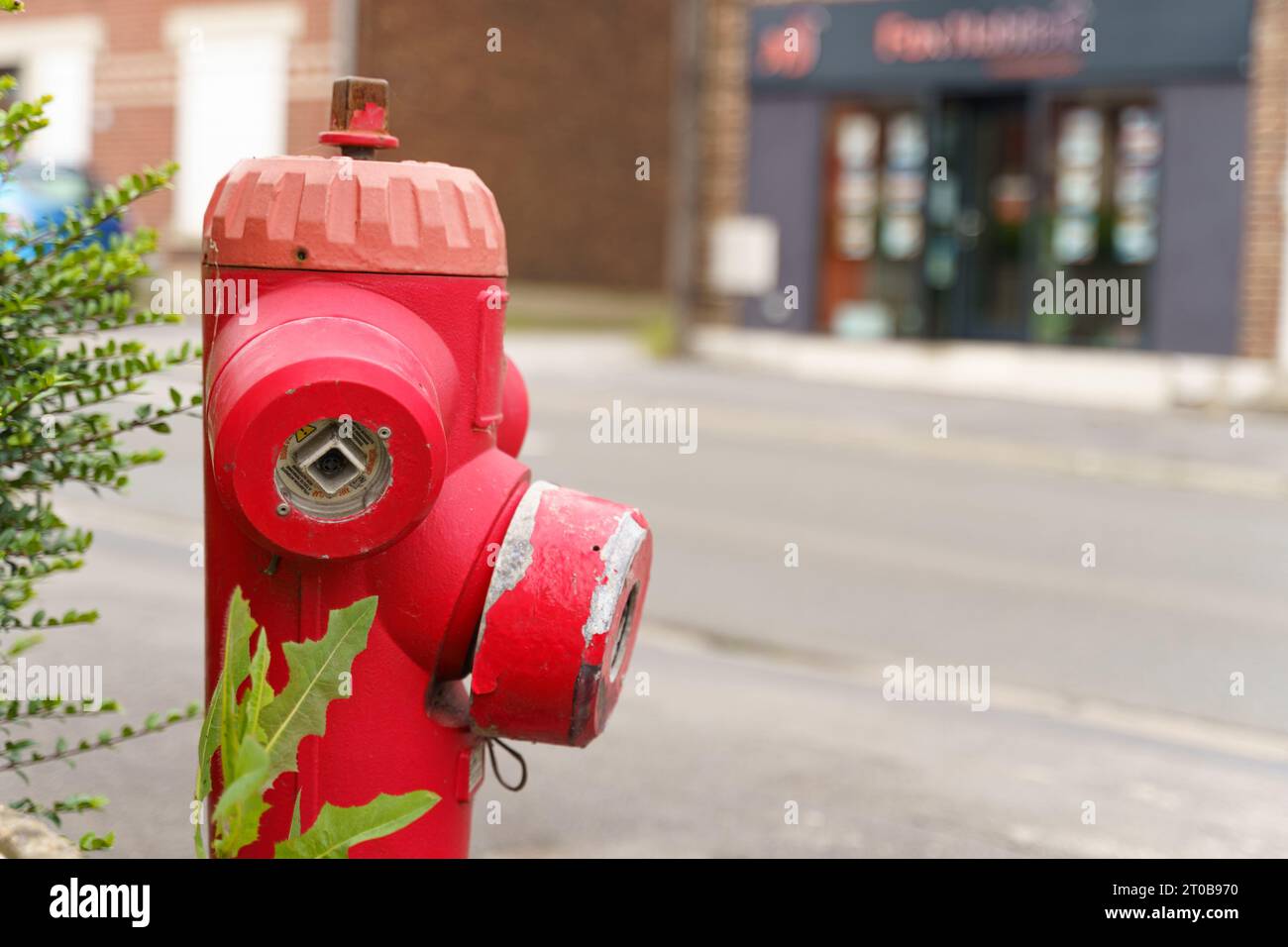 Red fire hydrant on a city street, for emergency access in case of fire ...