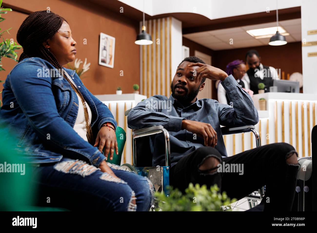 Tired African American guy in wheelchair arriving at luxury resort with ... Tired African American guy in wheelchair arriving at luxury resort with ...