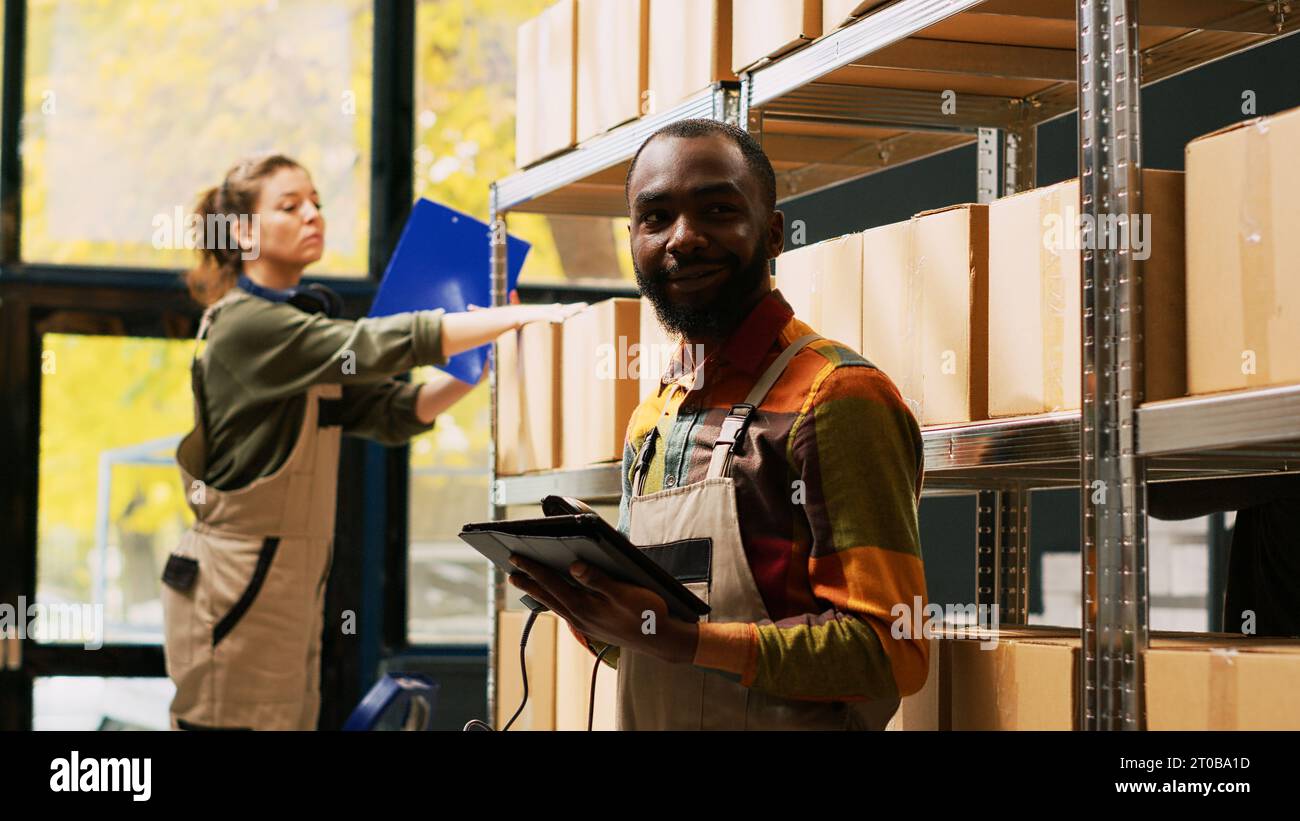 African american man using scanner in warehouse to scan barcodes on ...
