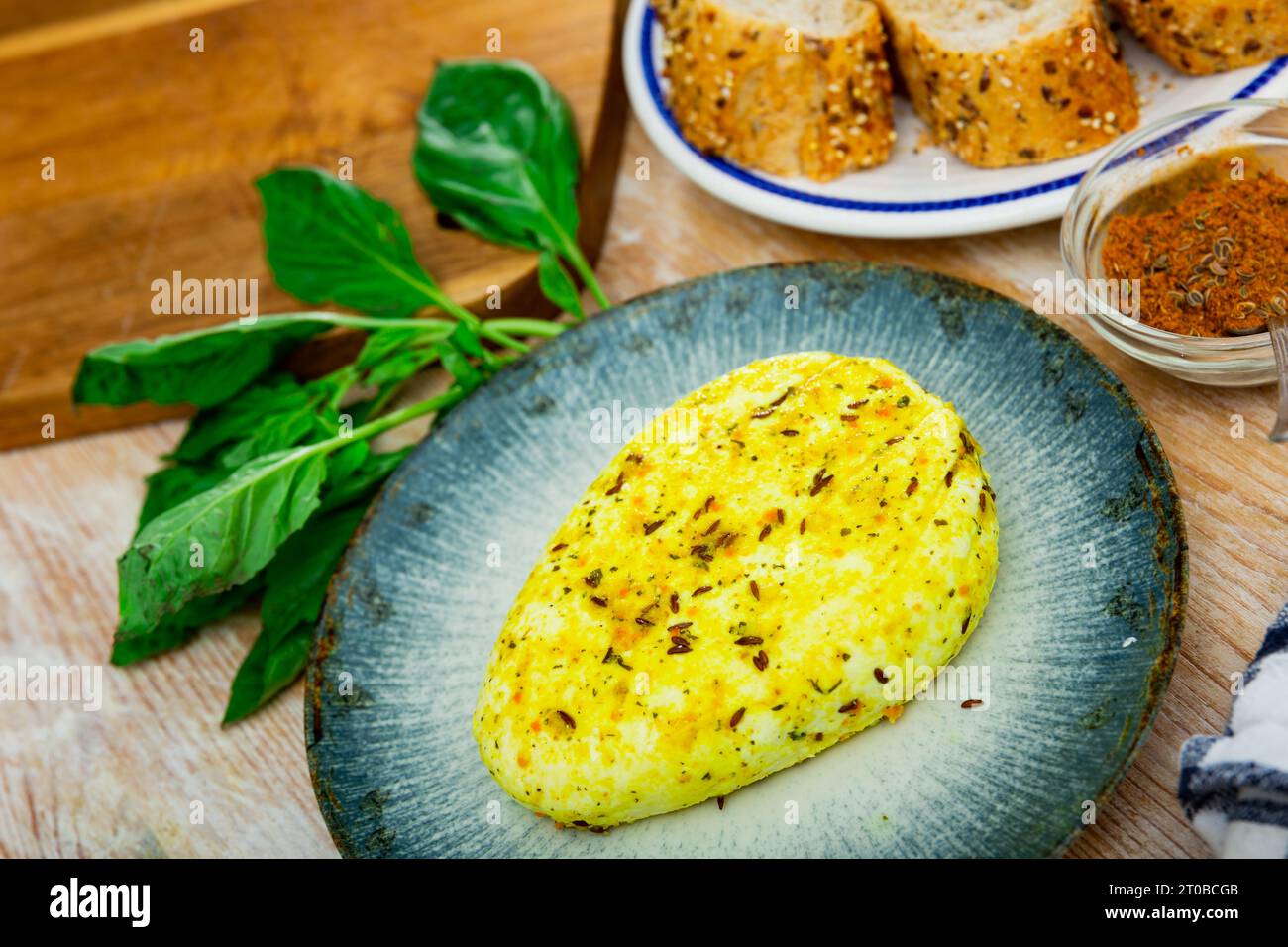 Traditional lithuanian farm cheese on plate with herbs and spices ...