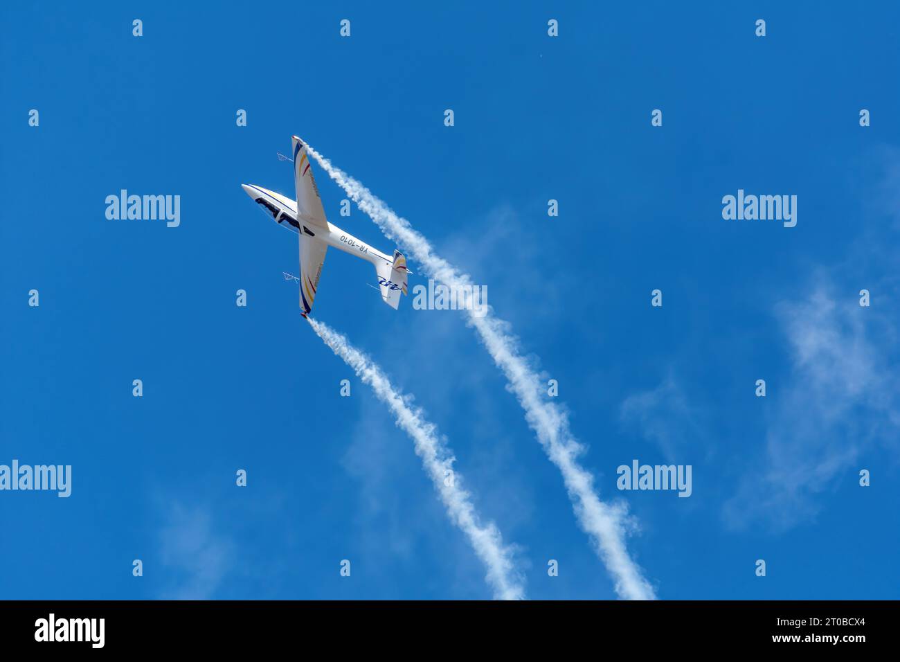 A commercial jet aircraft soaring through the sky, creating a white ...