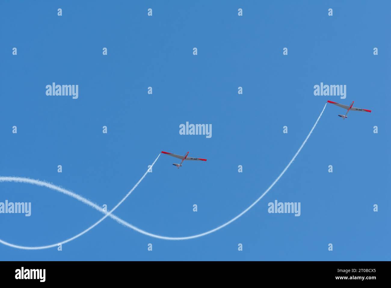 A line of airplanes take to the sky on a beautiful day, their wings ...