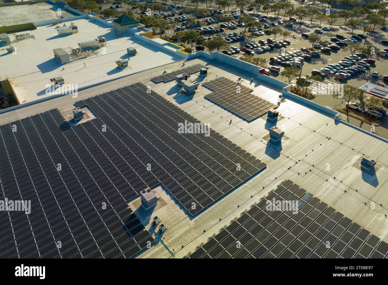 Aerial view of many photovoltaic panels installed on shopping mall roof ...