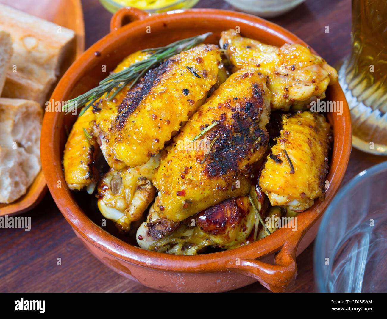 Baked chicken wings in clay pot Stock Photo - Alamy