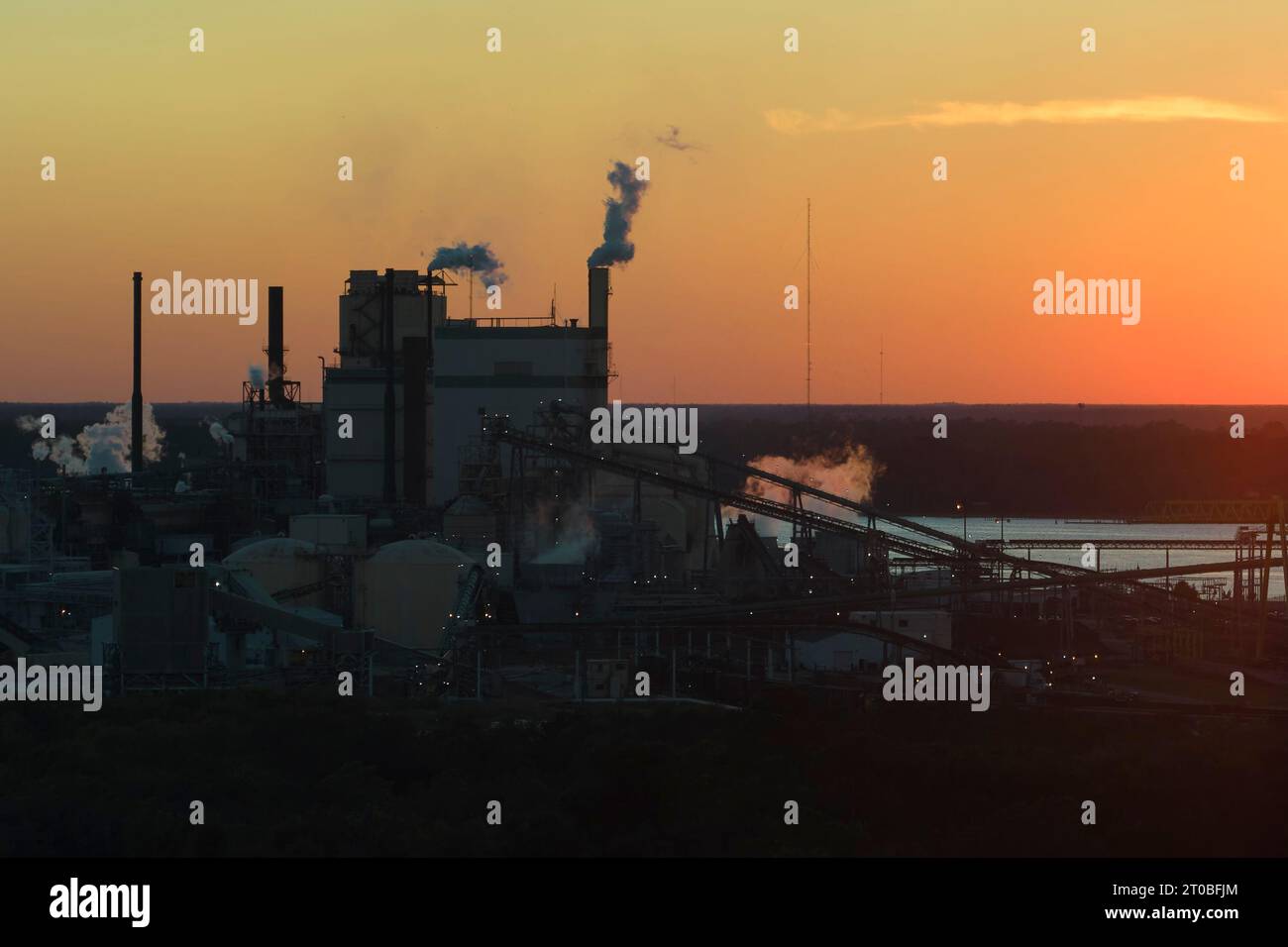 Aerial view of wood processing factory with smoke from production ...