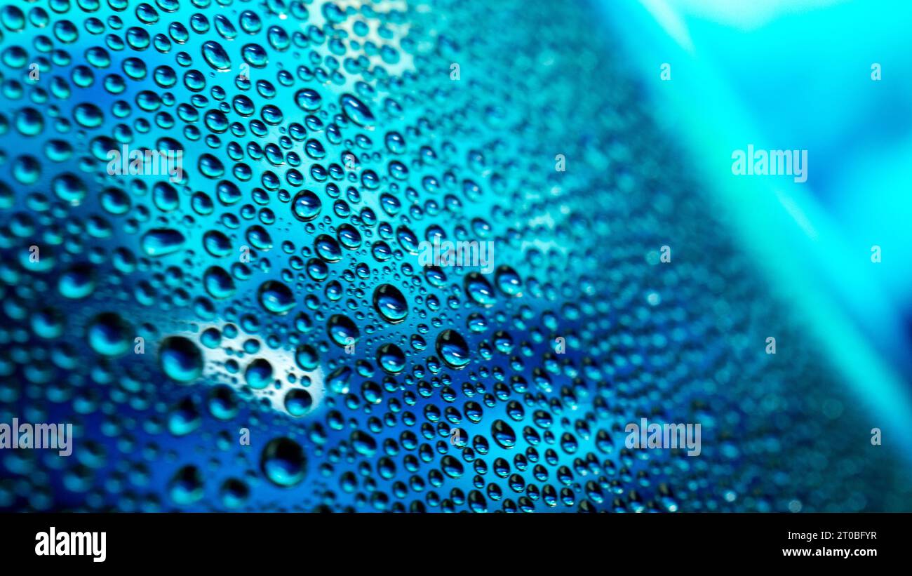 Macro of water drops over a colorful green and blue gradient background ...