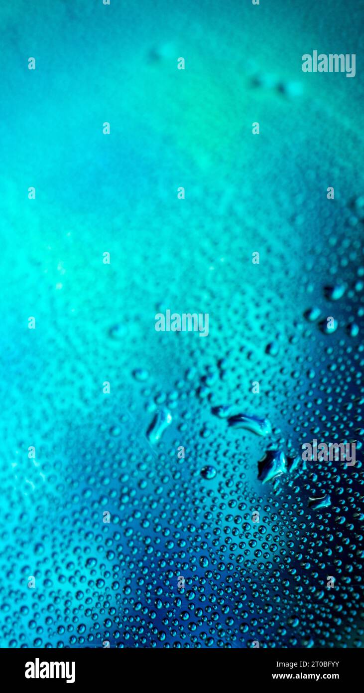 Macro of water drops over a colorful green and blue gradient background ...