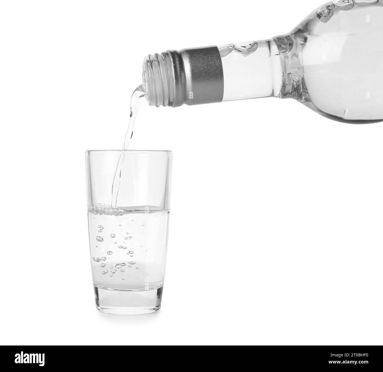Pouring of vodka from bottle into glass on white background Stock Photo ...