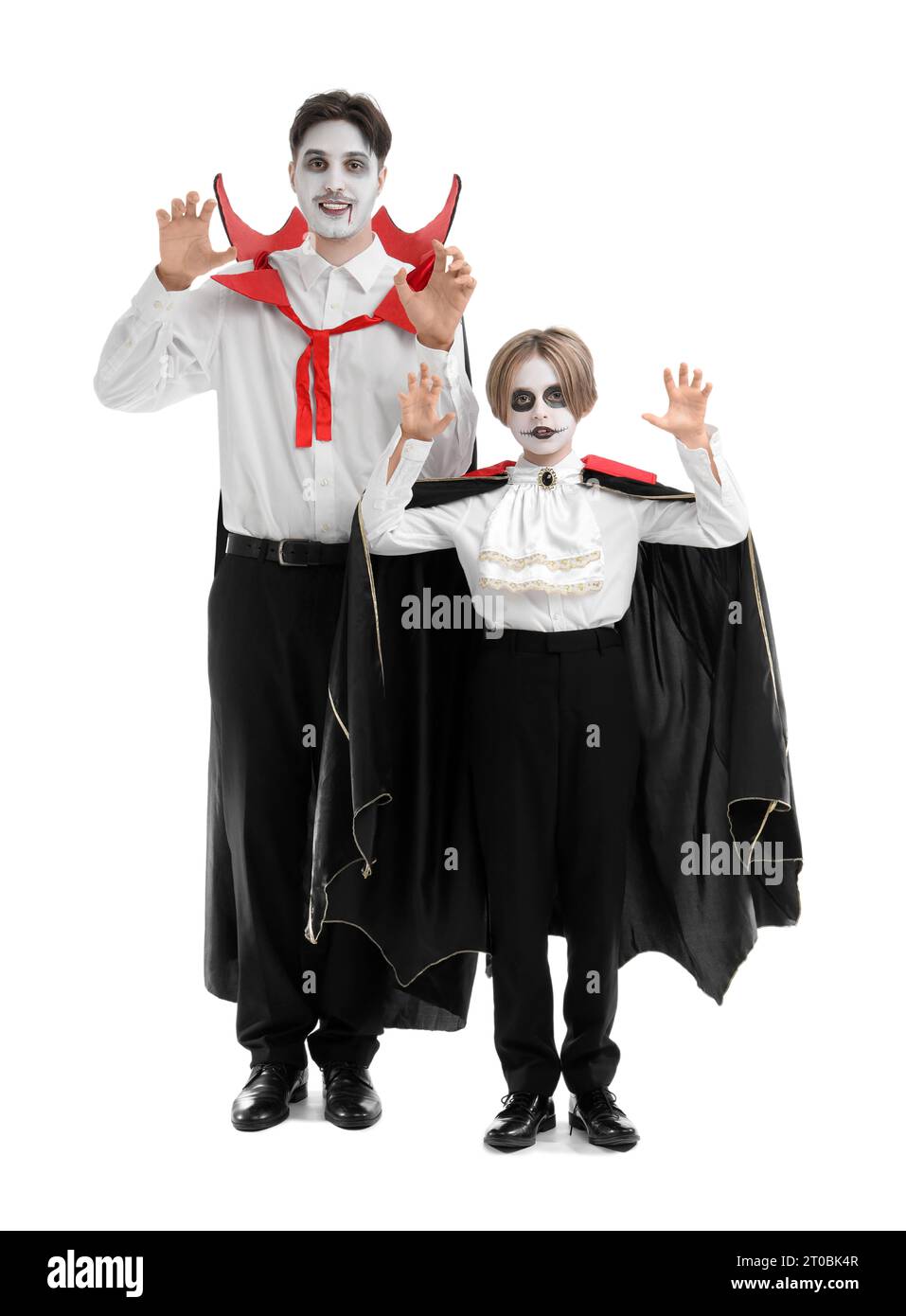 Little boy with his father dressed for Halloween as vampires on white ...