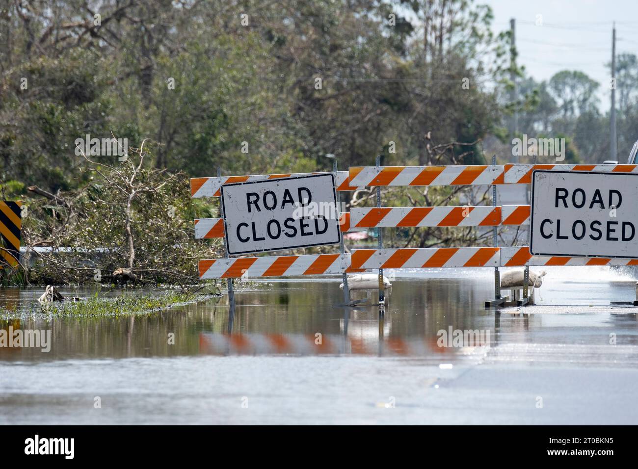 Hurricane flooded street with road closed signs blocking driving of ...