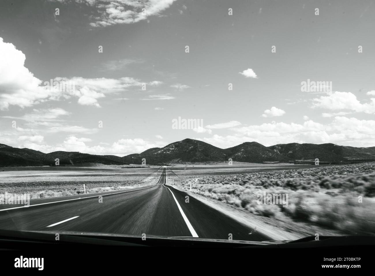 Looking out the car window at the road leading to the mountains Stock ...