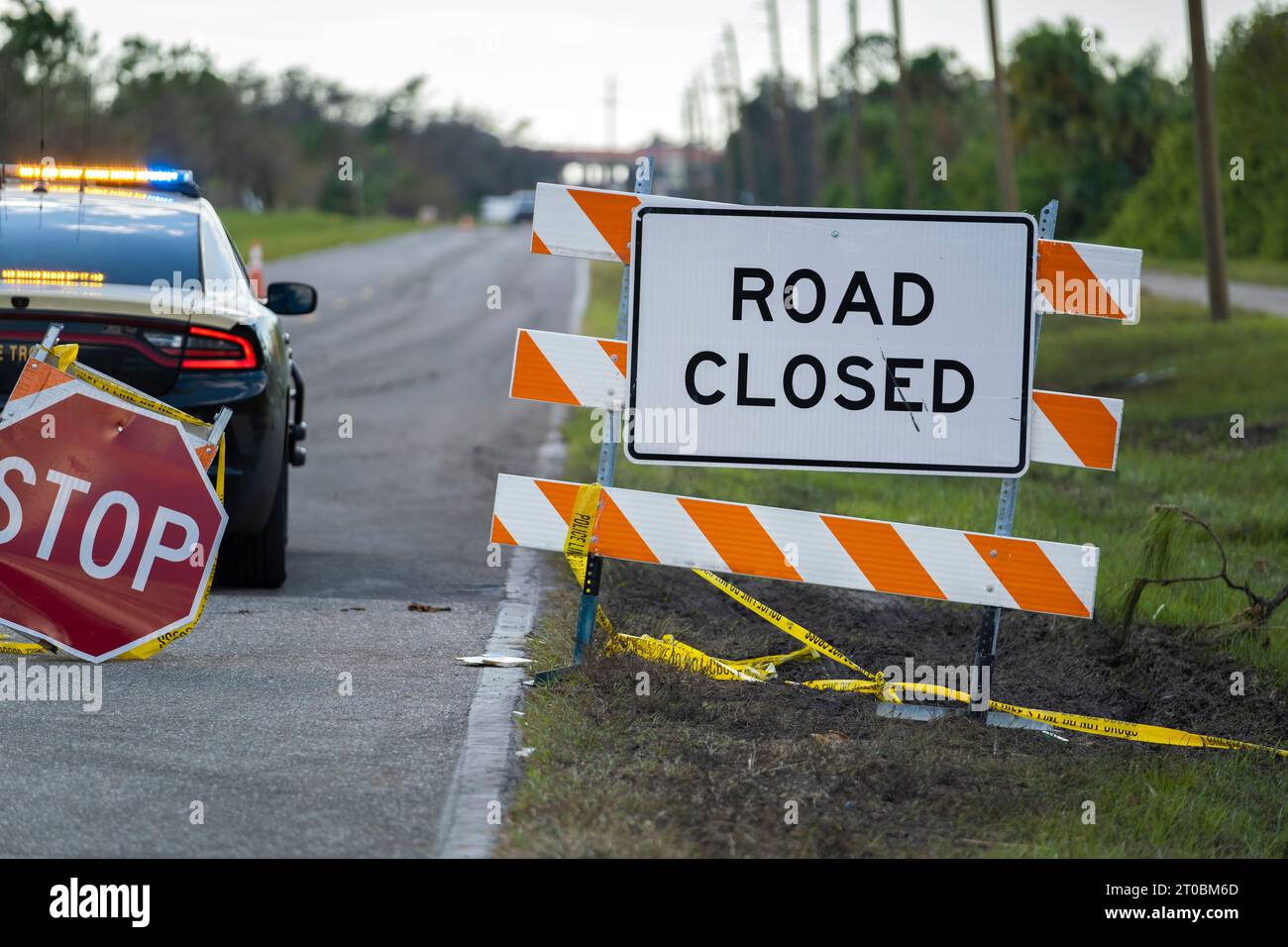 Police patrol car at warning roadworks sign and safety barrier on city ...