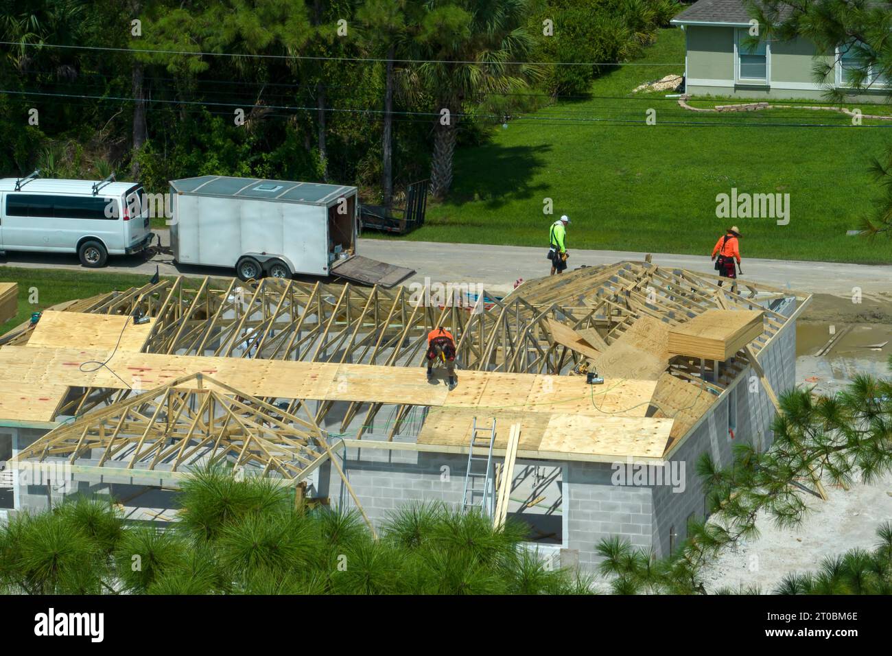 Professional builders working on roof construction of unfinished ...