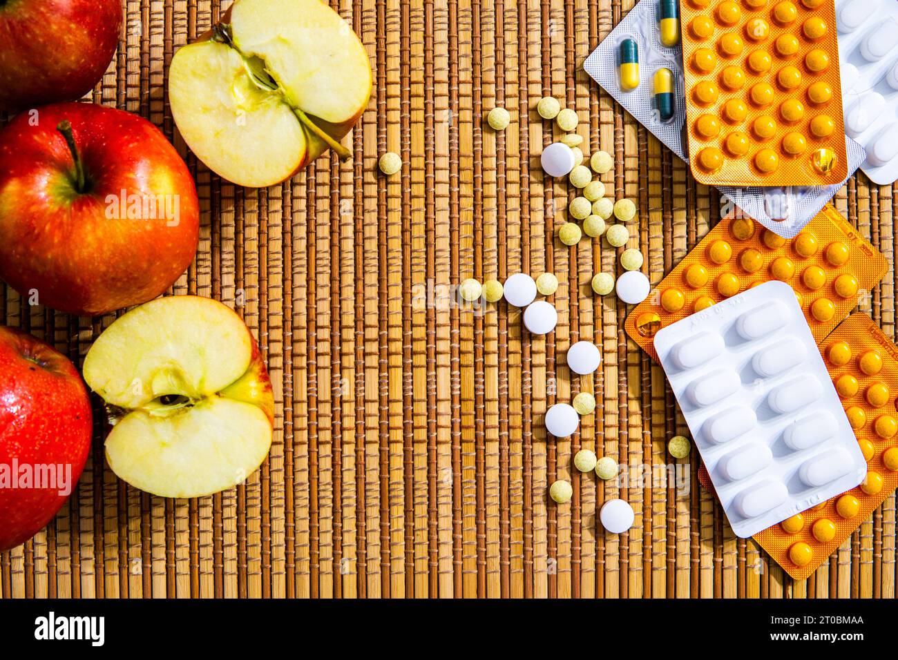 Apples and medicine drugs on straw mat background modern medicine ...