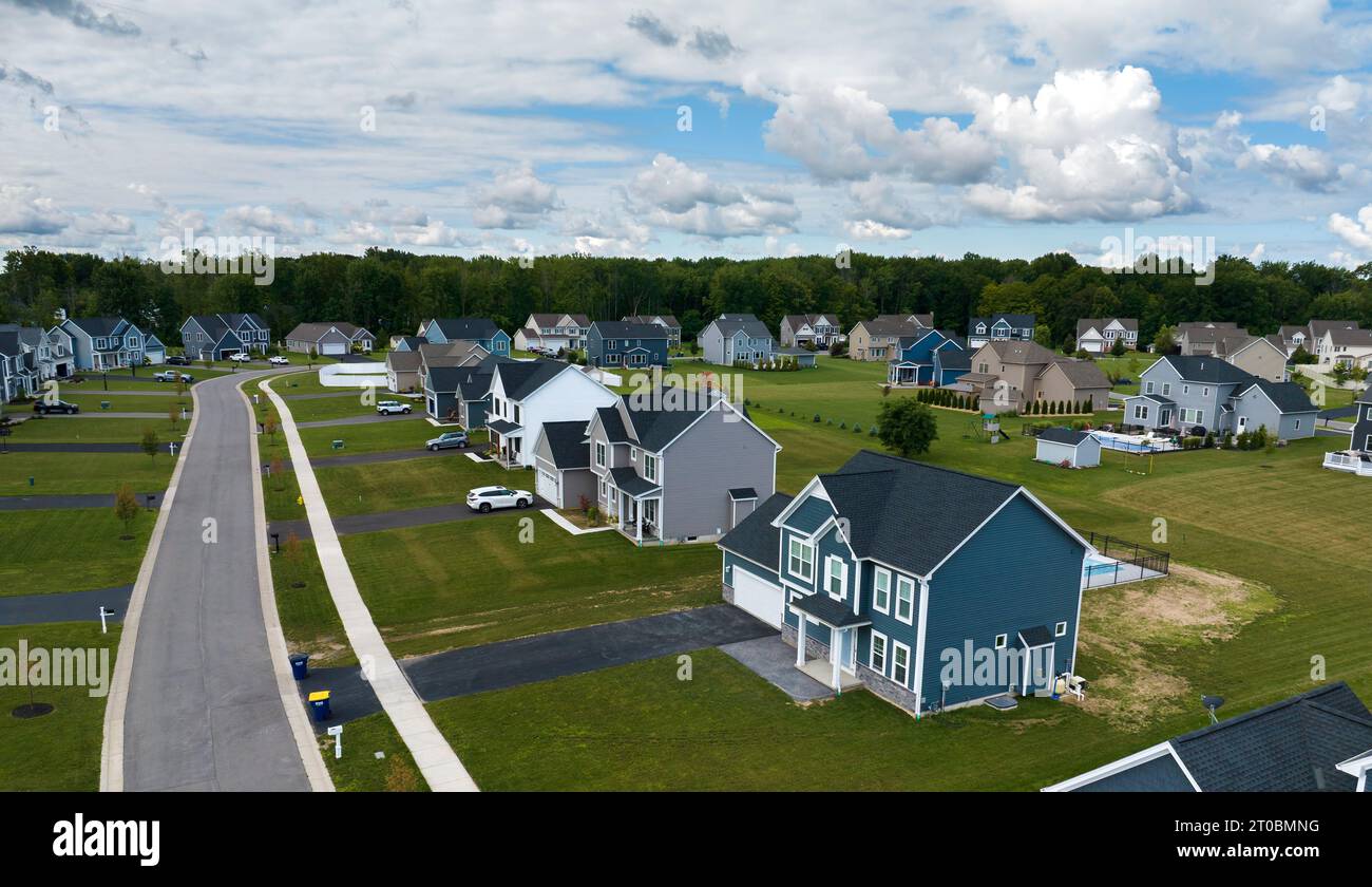 Upscale suburban homes with large backyards and green grassy lawns in ...