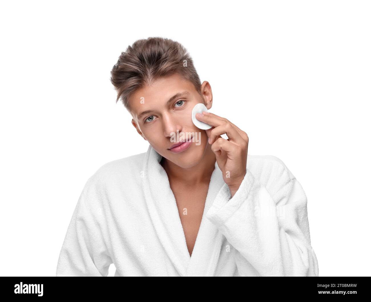 Handsome man cleaning face with cotton pad on white background Stock ...